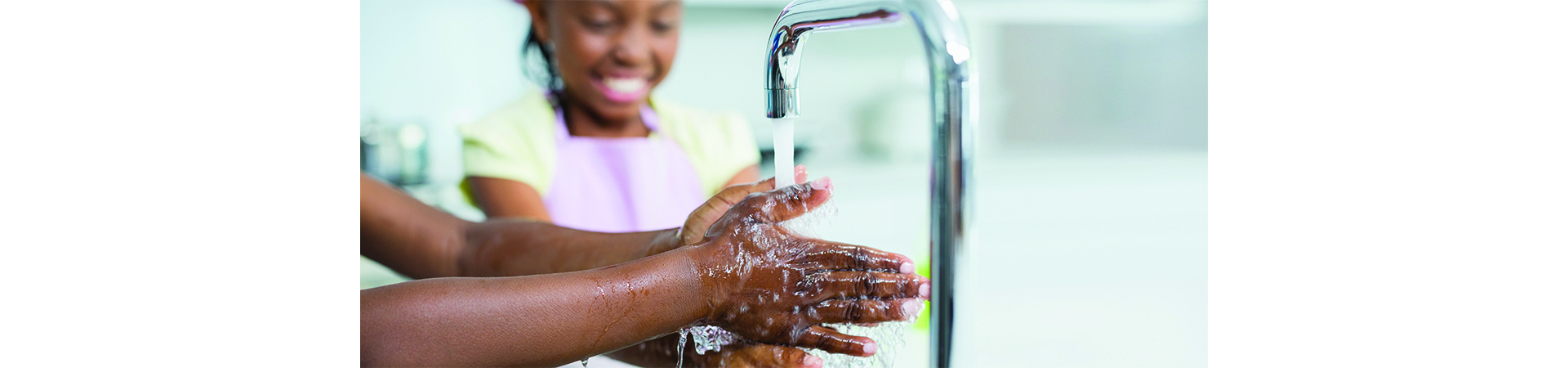 Girl and mom washing hands